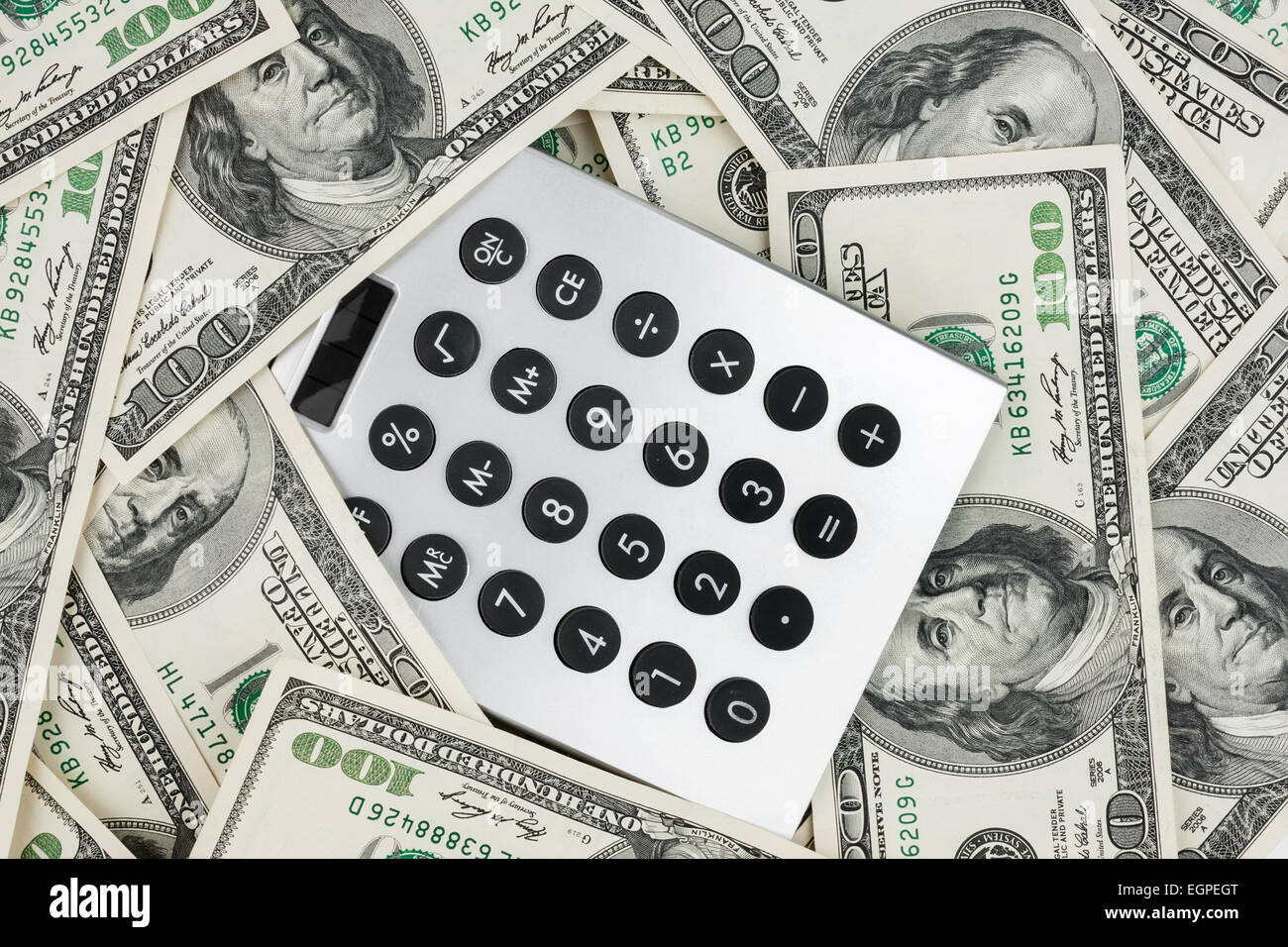 Background of $ 100 bills and a calculator can be used as background ...