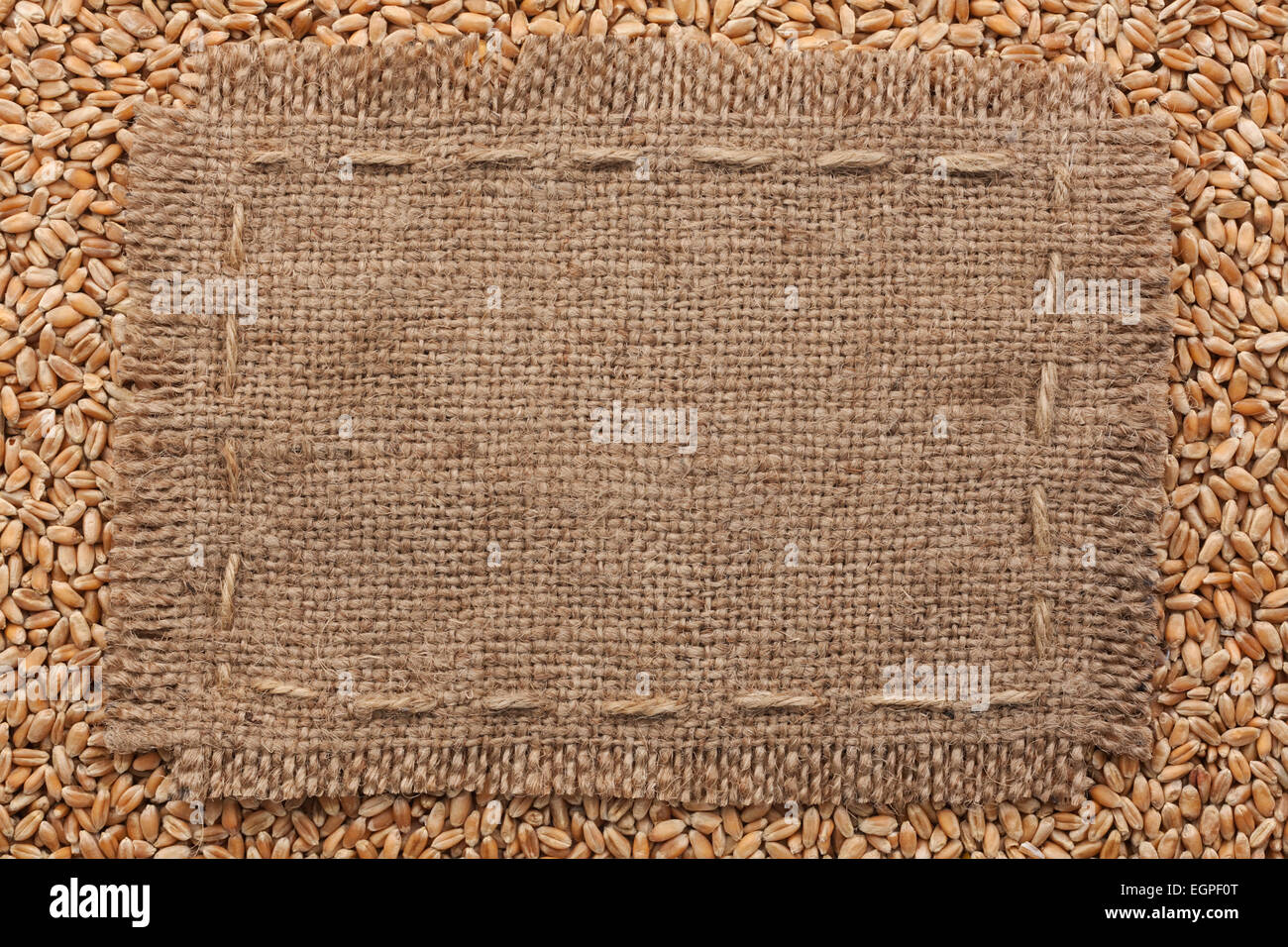 Frame of burlap lying on a wheat background, with place for your text ...