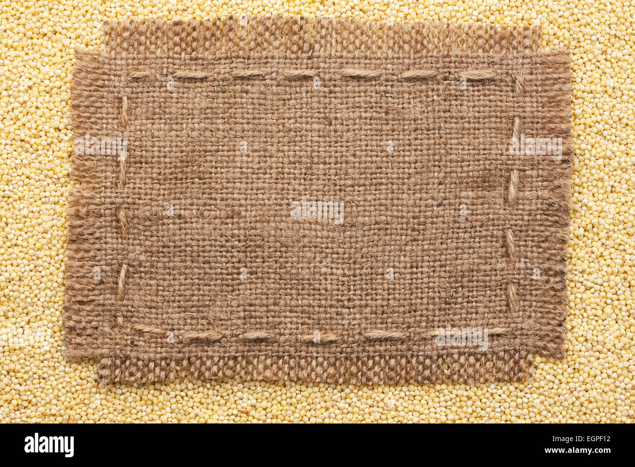 Frame of burlap lying on a millet background, with place for your text ...
