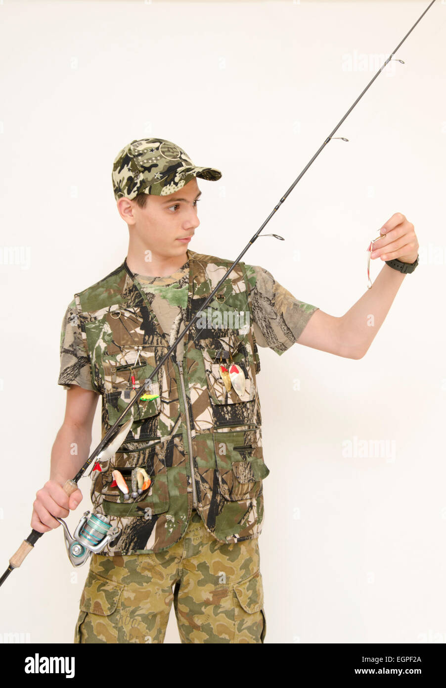 Amazed teenager fishing small fish islolated on white background Stock ...