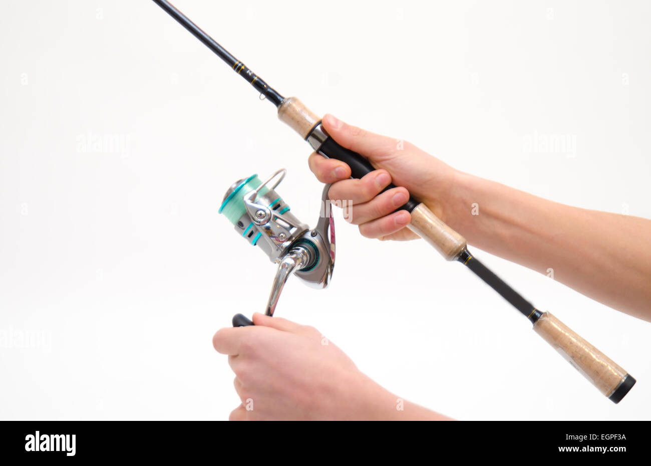 Rod with reel in hand isolated on white background Stock Photo - Alamy