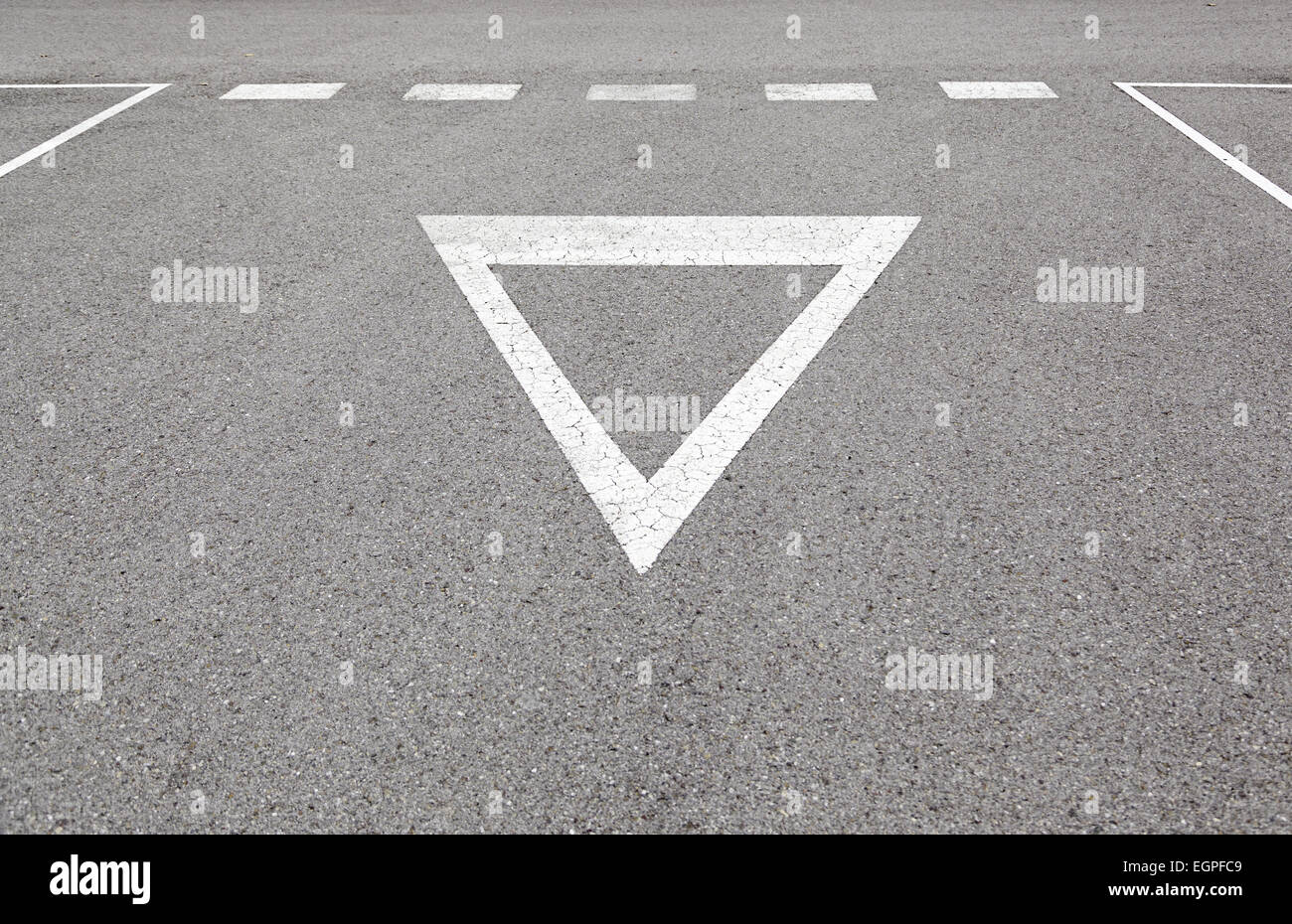 Give way sign on asphalt, detail of a traffic signal at the ciduad ...