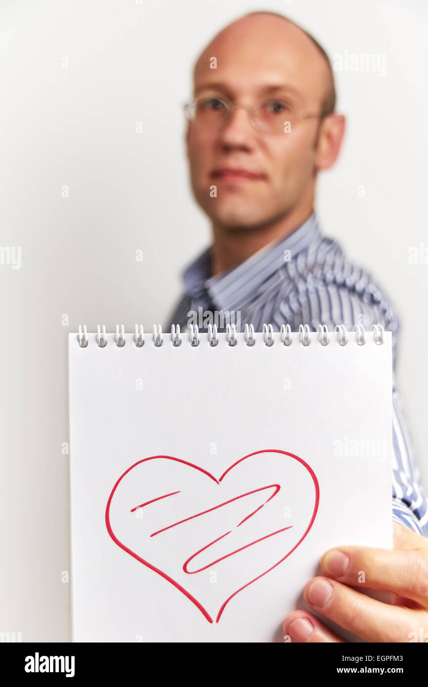 Man showing notebook organizer with red heart Stock Photo - Alamy