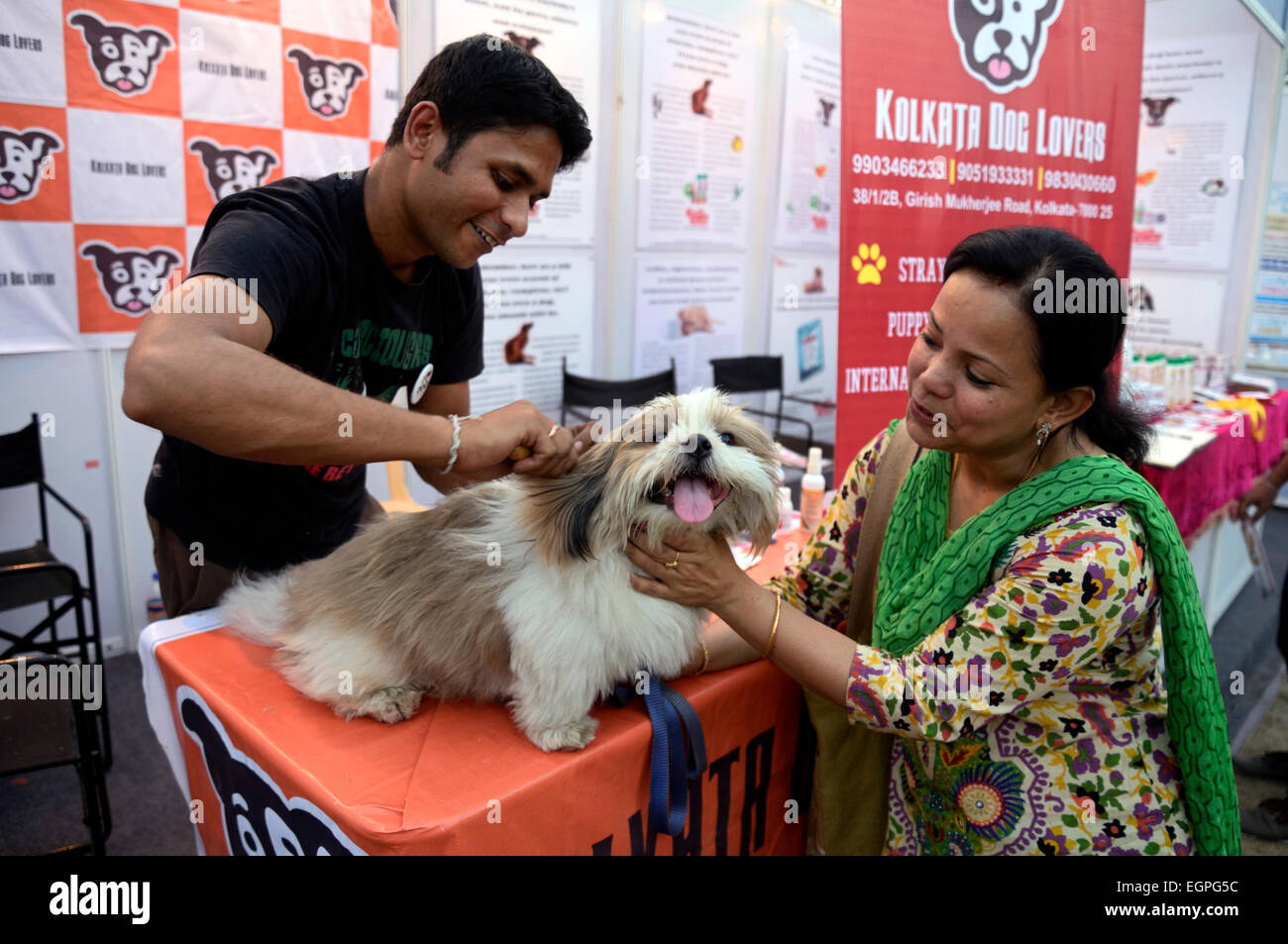 A woman with his pet joining the first pet convention in Kolkata. It is ...
