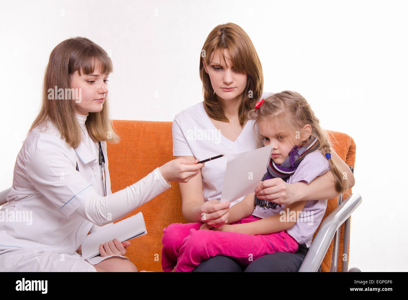 Doctor pediatrician examines a sick child at home in the presence of my ...