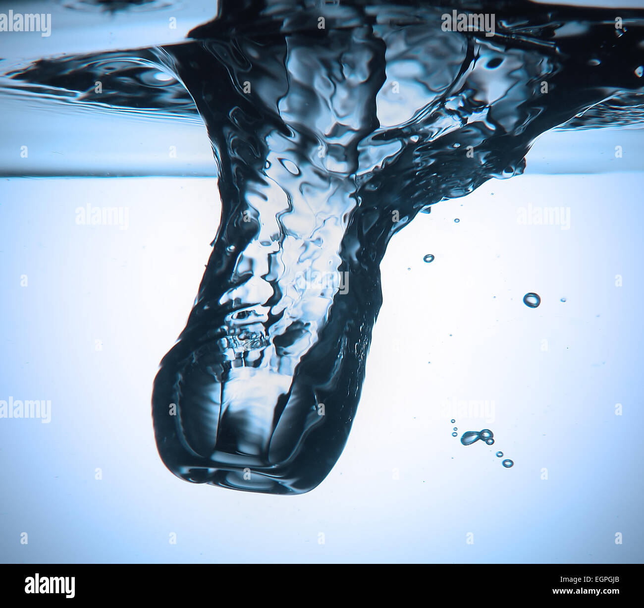 Underwater view of object splashing into water with blue background ...