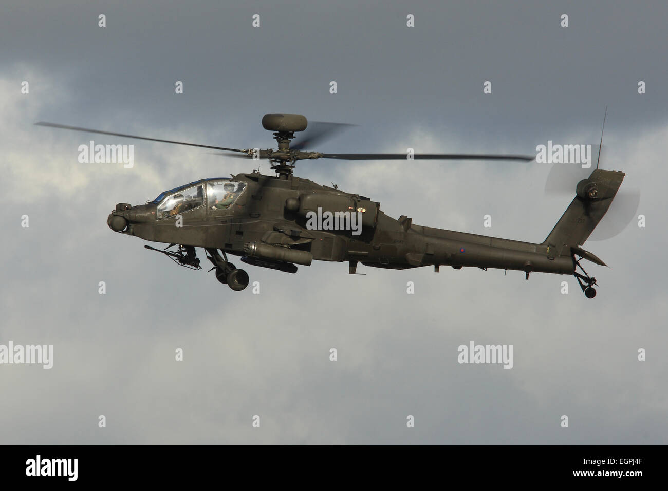 Army Air Corps Apache AH1 Attack helicopter flies in storm clouds on a ...