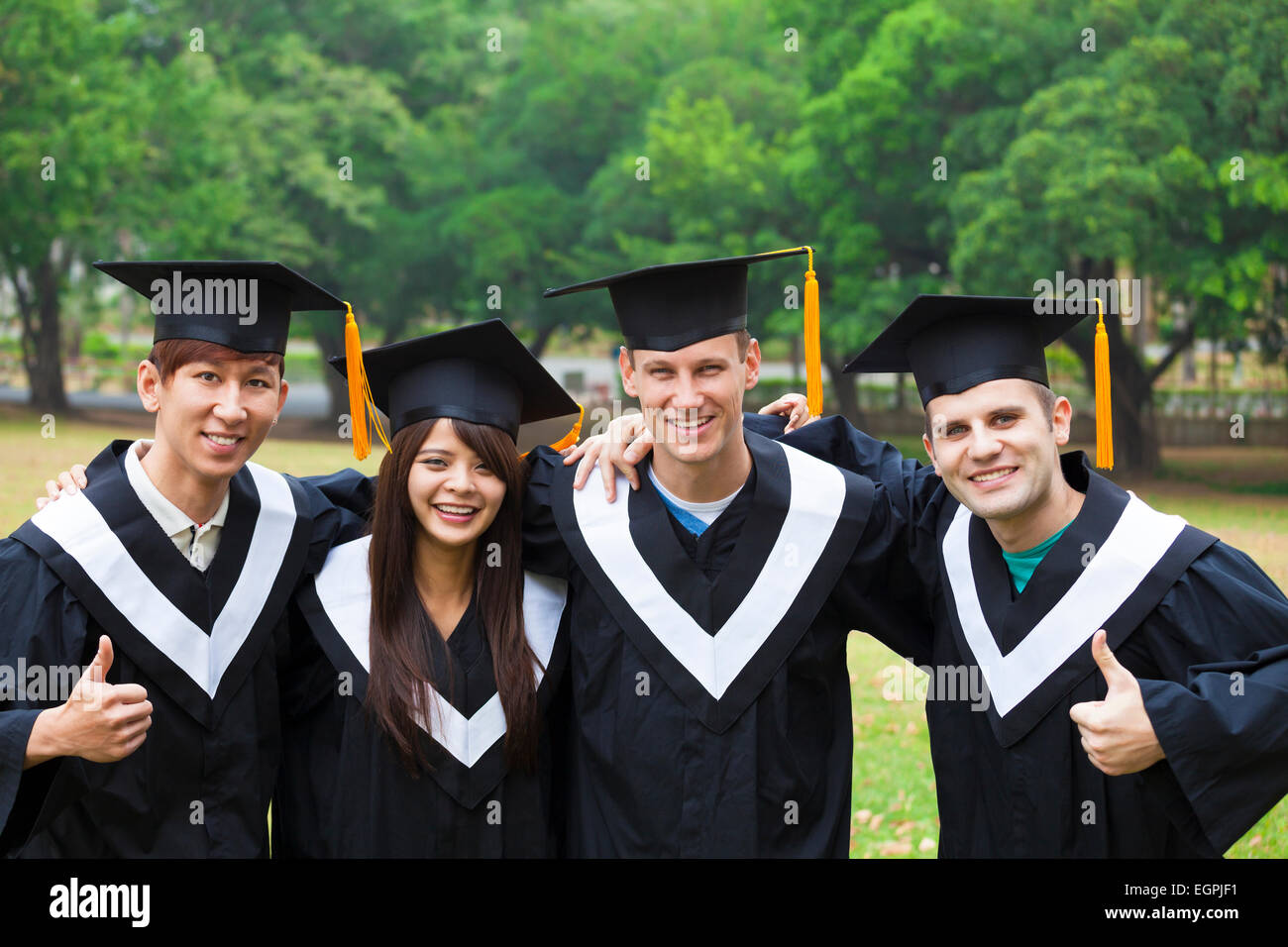 Happy graduation students thumbs up hi-res stock photography and images ...
