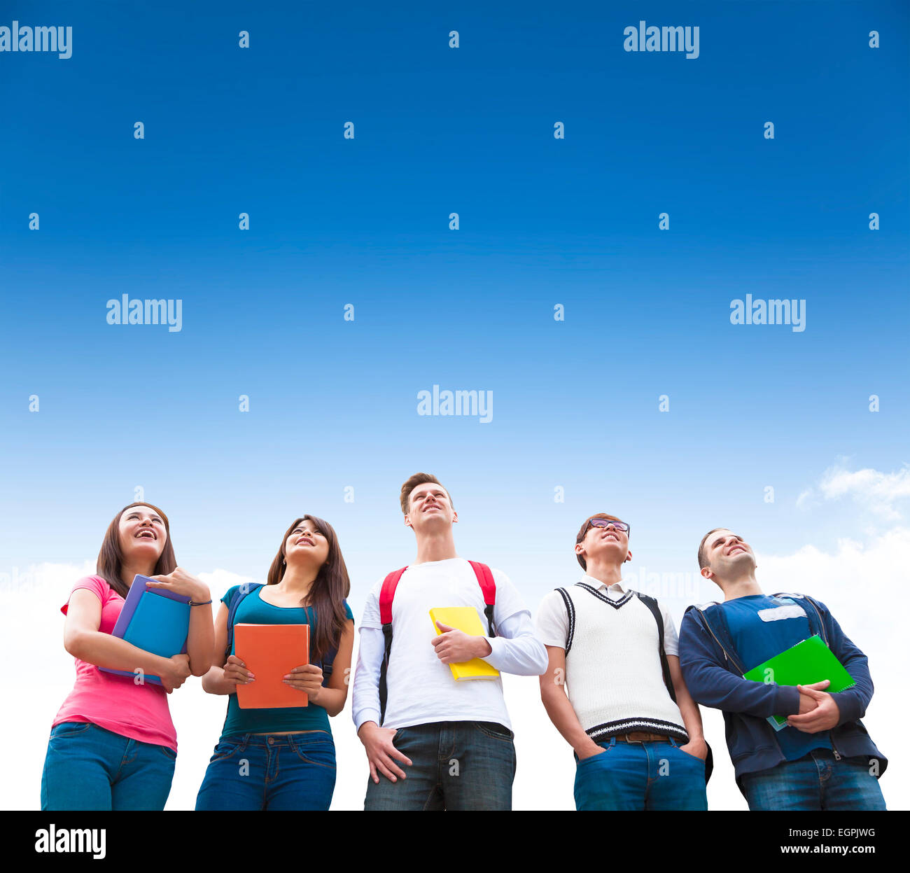 Happy young group of students standing together Stock Photo - Alamy