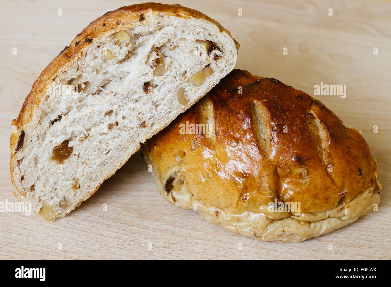 Fresh whole grain bread cut in half on cutting board Stock Photo - Alamy