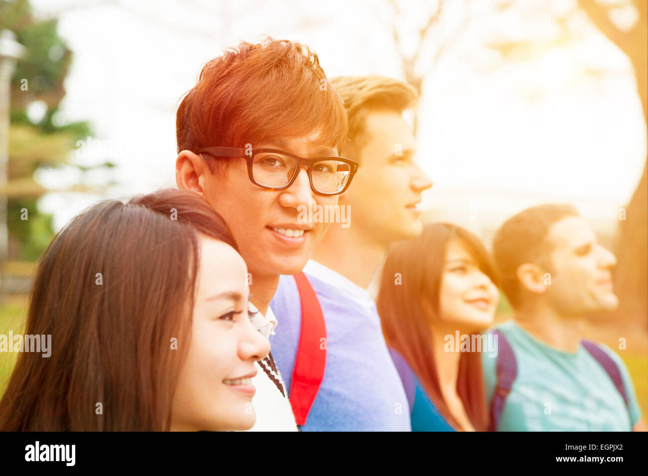 Happy young group of students standing together Stock Photo - Alamy