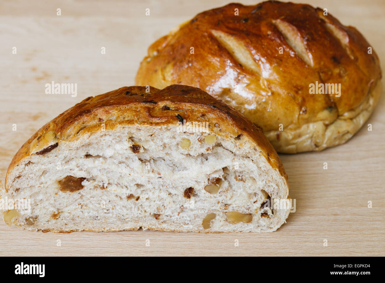 Fresh whole grain bread cut in half on cutting board Stock Photo - Alamy