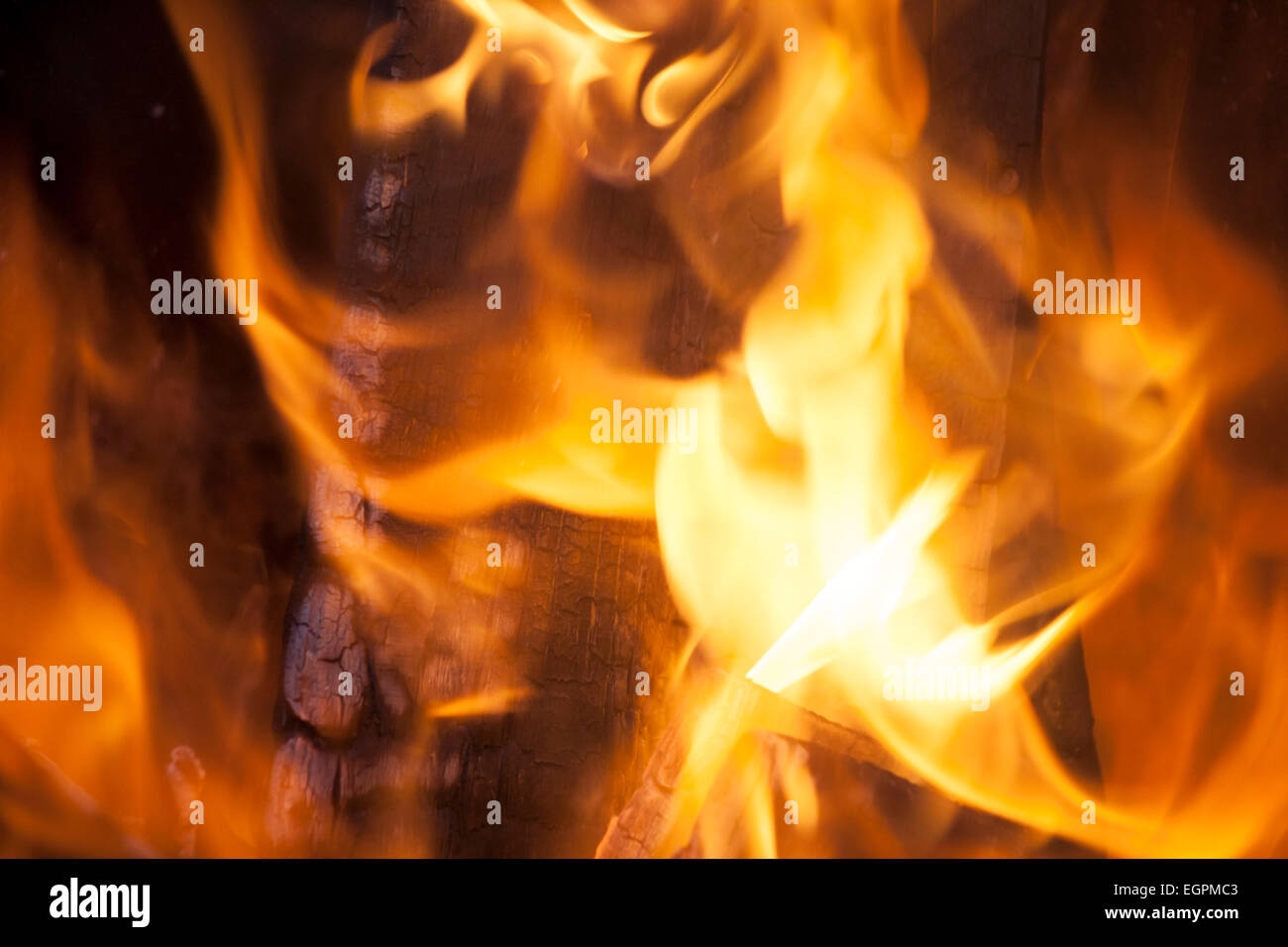 Flames from burning wood dancing yellow and orrange Stock Photo - Alamy