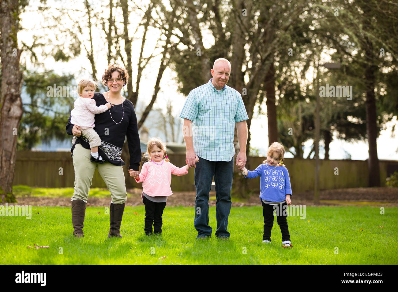 Lifestyle photo of a family of five including mother, father, and three ...