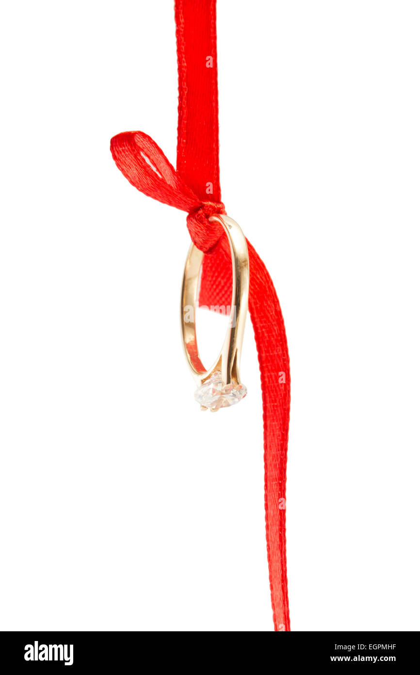gold ring and a red ribbon with a bow Stock Photo - Alamy