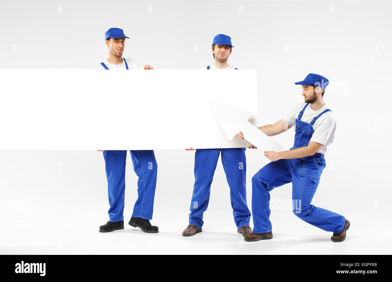 Three handsome guys holding signs Stock Photo - Alamy