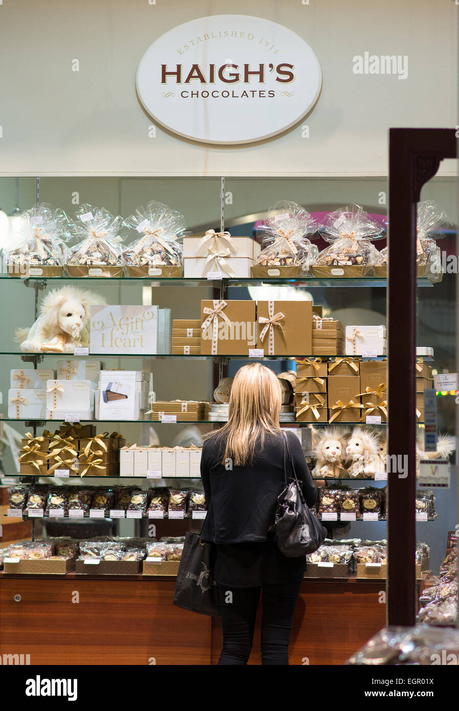 Young Woman Browsing Haigh's Chocolate Store Interior Stock Photo - Alamy