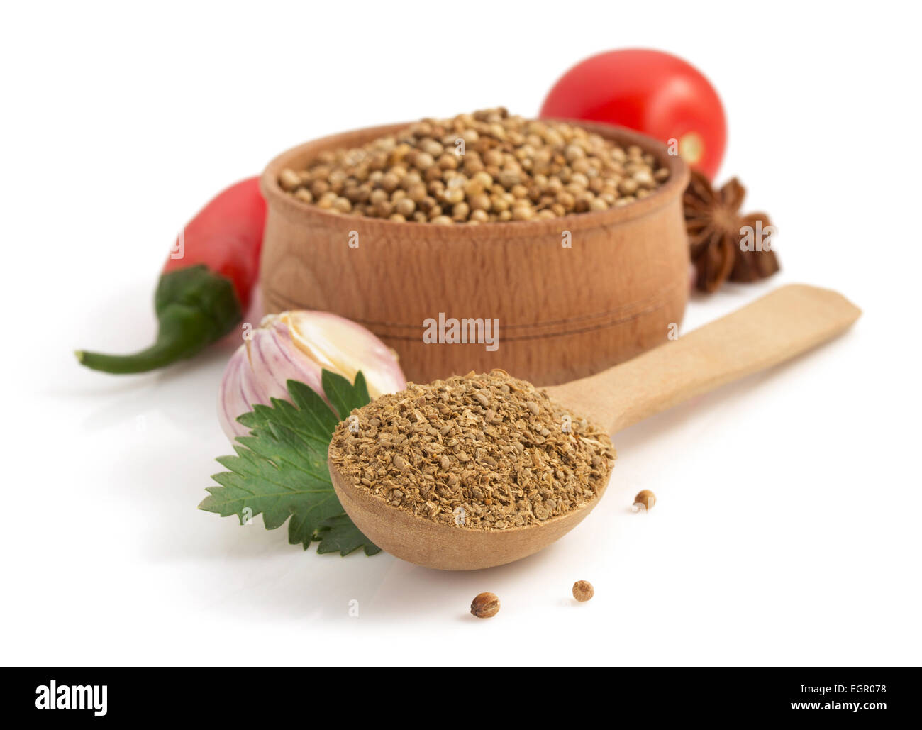coriander spices in spoon isolated on white background Stock Photo - Alamy