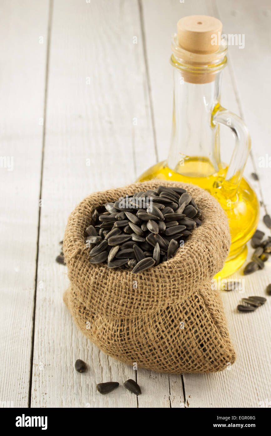 sunflower oil and seeds on wooden background Stock Photo - Alamy