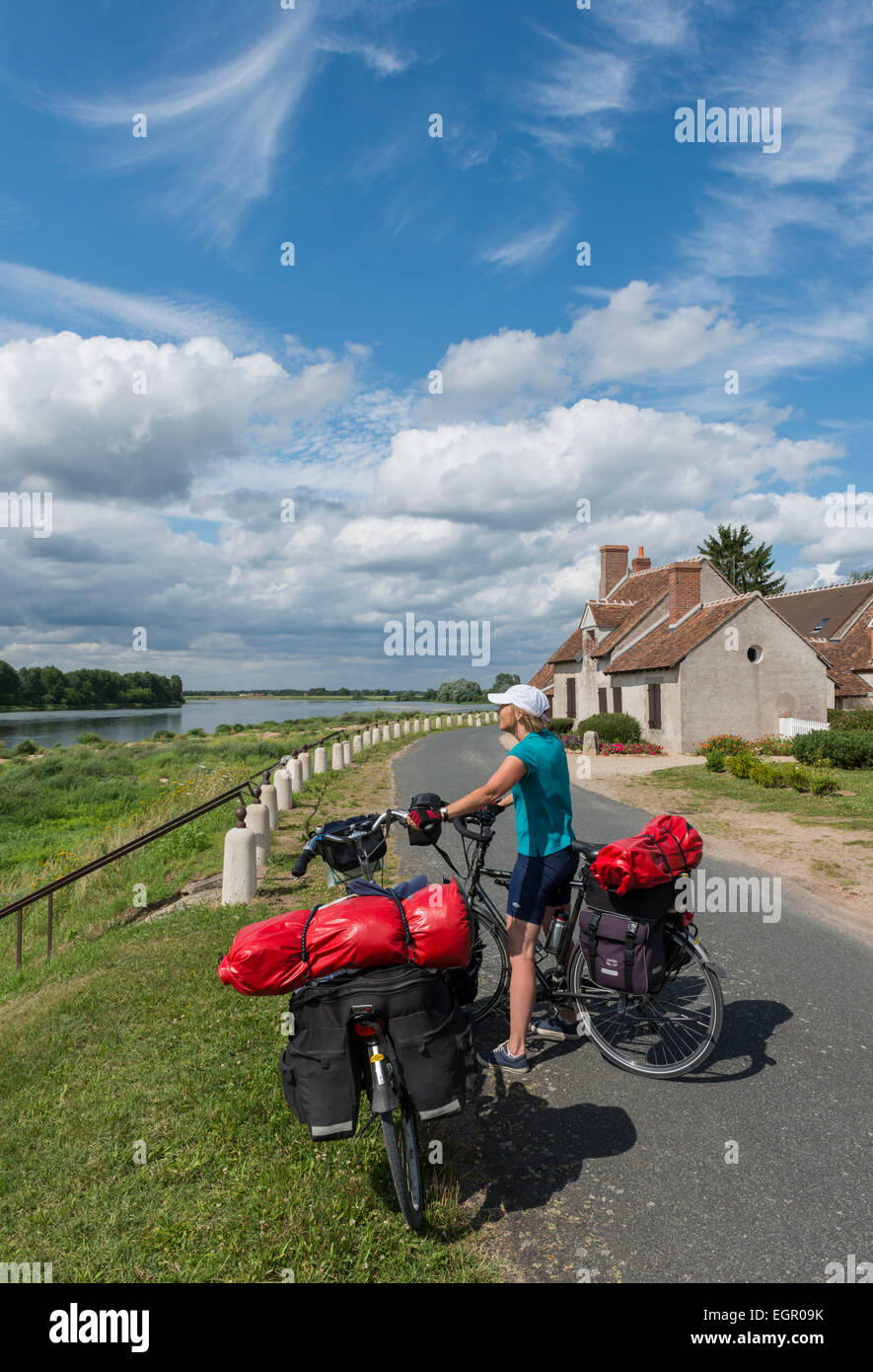 Biker with two bikes on a dike near the Loire in France Stock Photo - Alamy