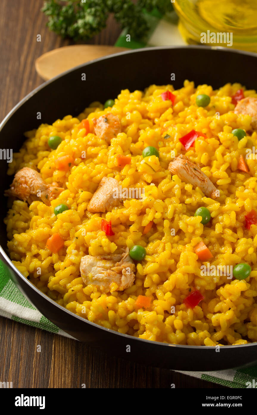 frying pan full of rice on wooden background Stock Photo - Alamy