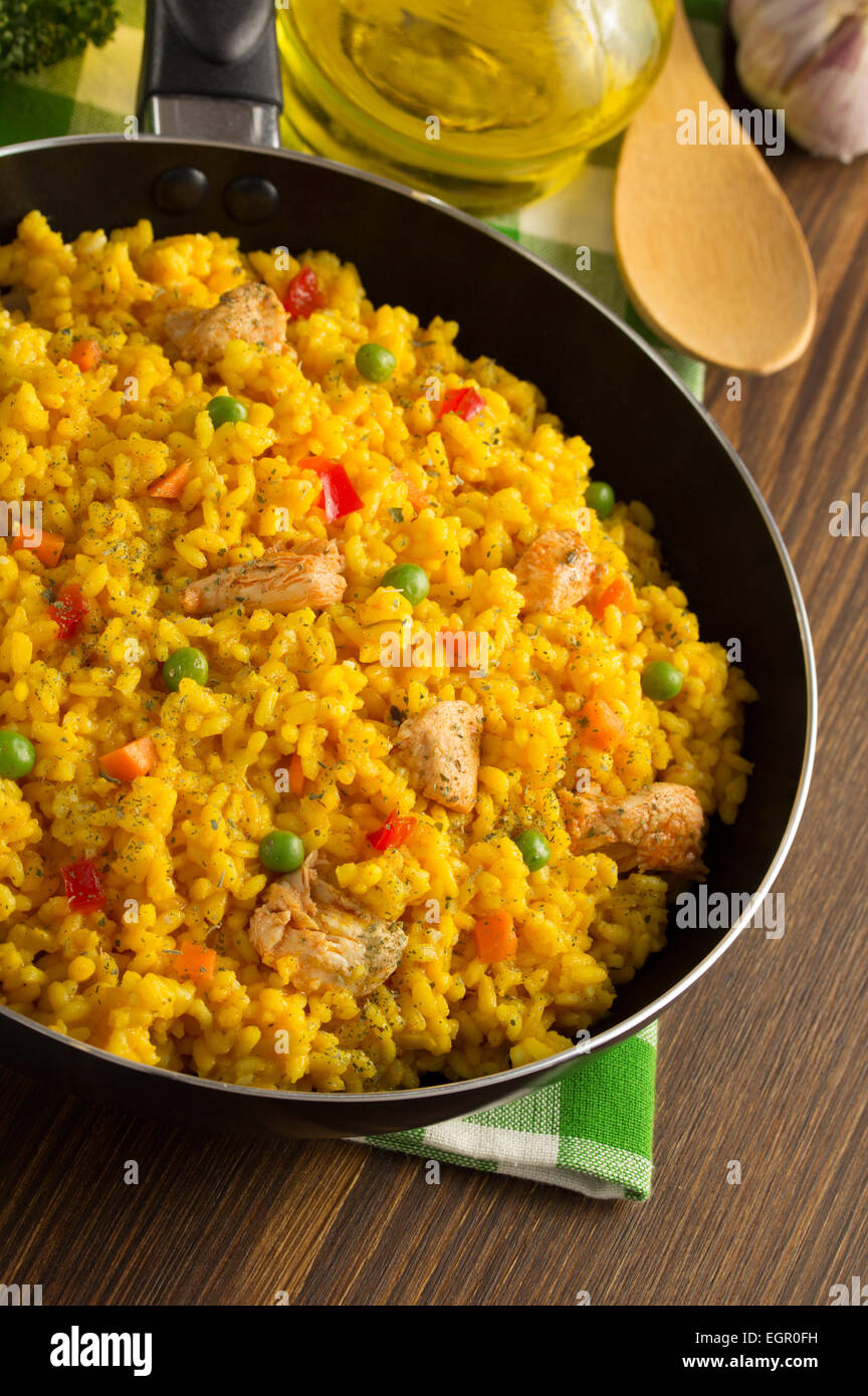 frying pan full of rice on wooden background Stock Photo - Alamy