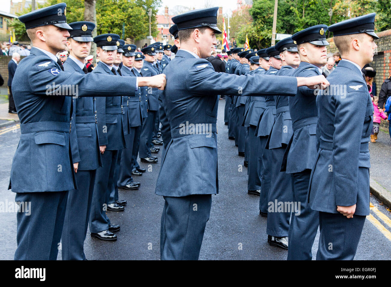 Three ranks of RAF personal standing to attention in a street lining ...