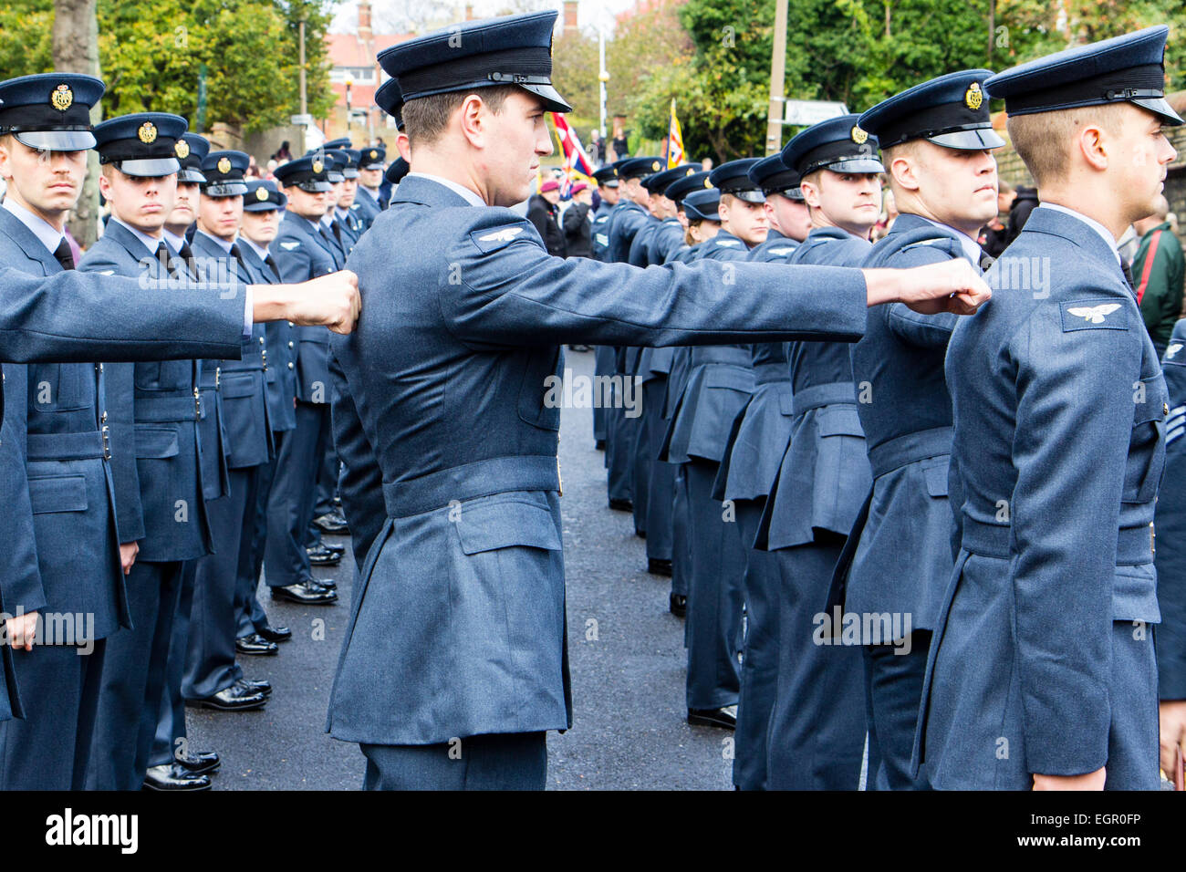 Three ranks of RAF personal standing to attention in a street lining ...