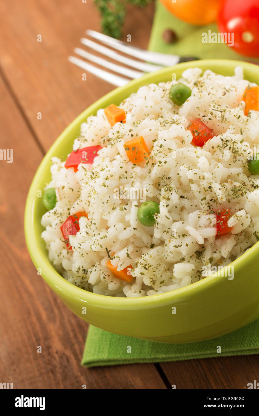 bowl full of rice isolated on wooden background Stock Photo - Alamy
