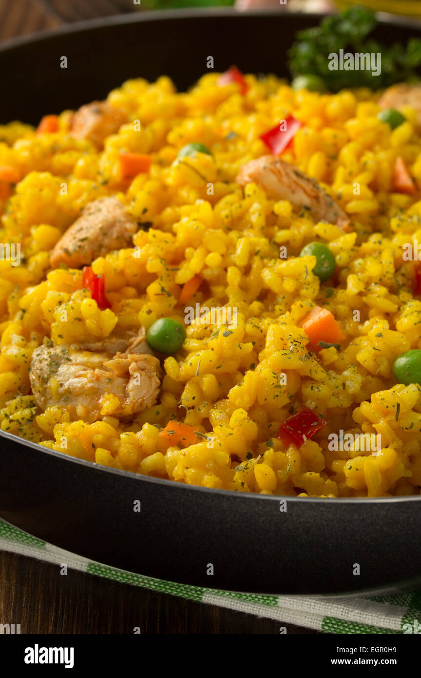 frying pan full of rice on wooden background Stock Photo - Alamy