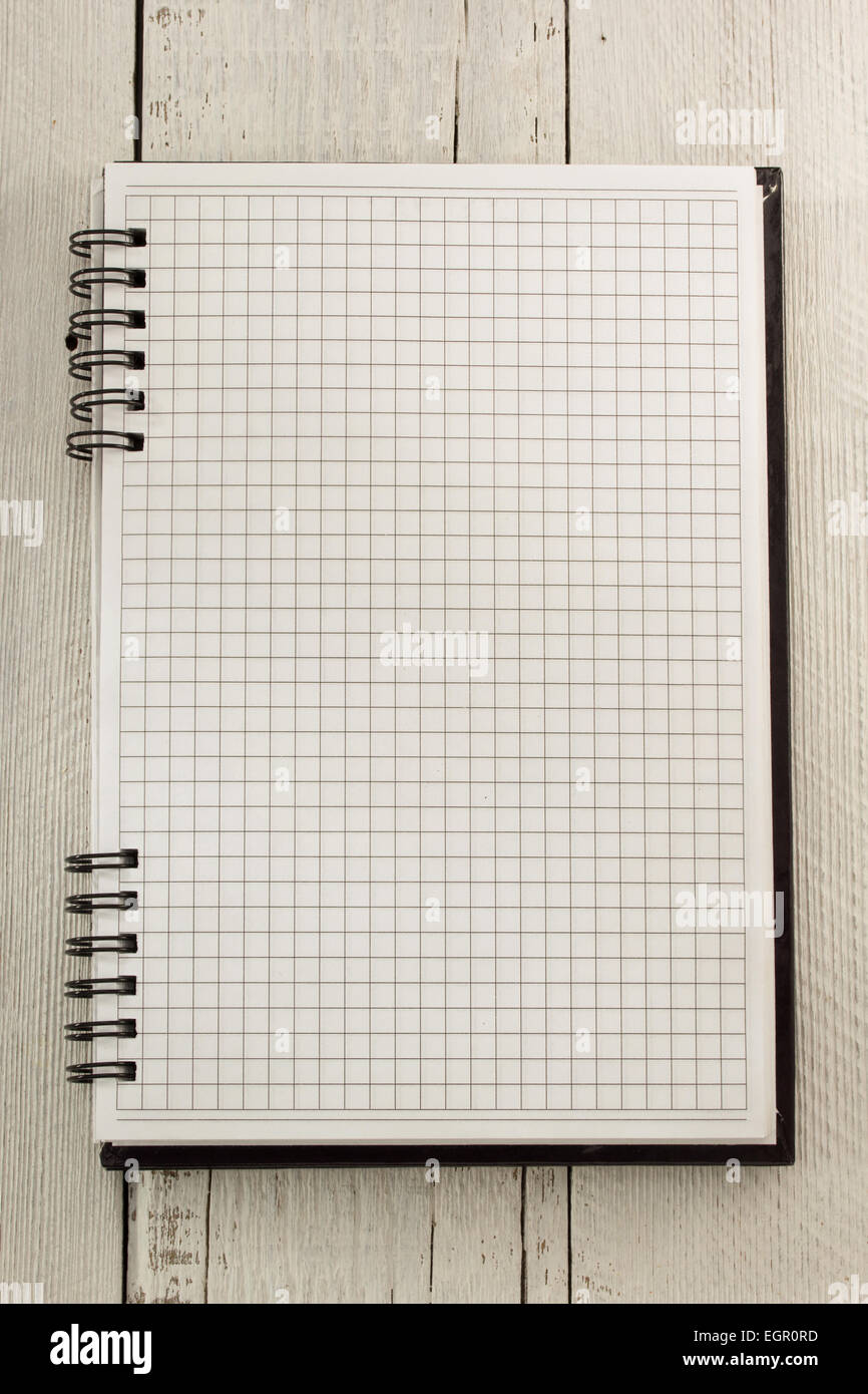 checked notebook on wooden background Stock Photo - Alamy