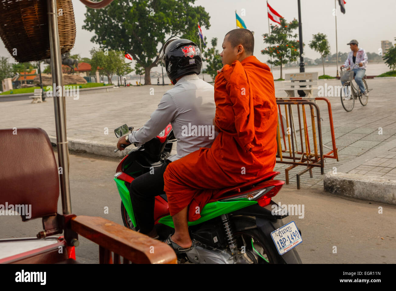 A Buddhist monk taking a ride on motorcycle in Phnom Penh, Cambodia ...