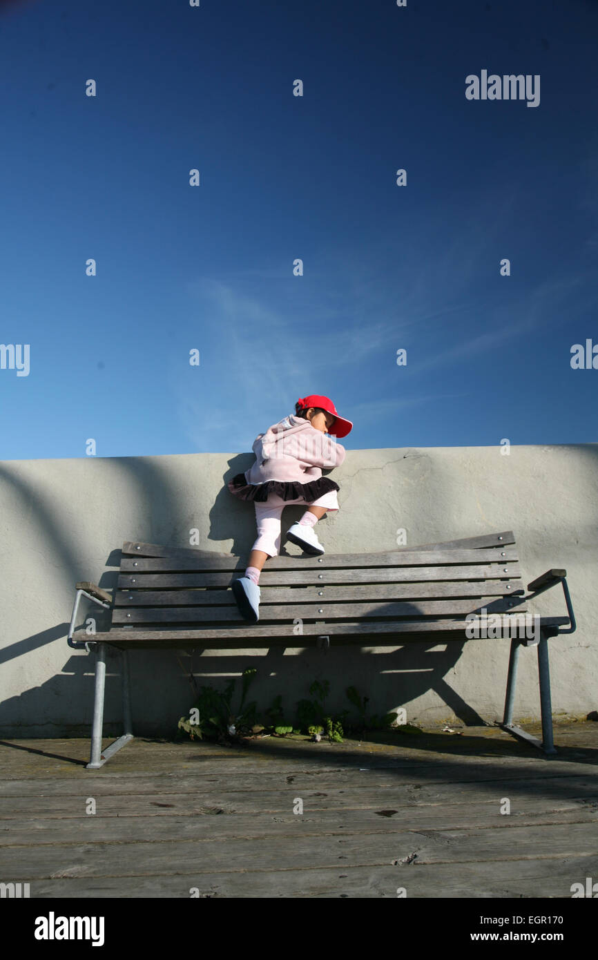 child climbing at a bench Stock Photo - Alamy