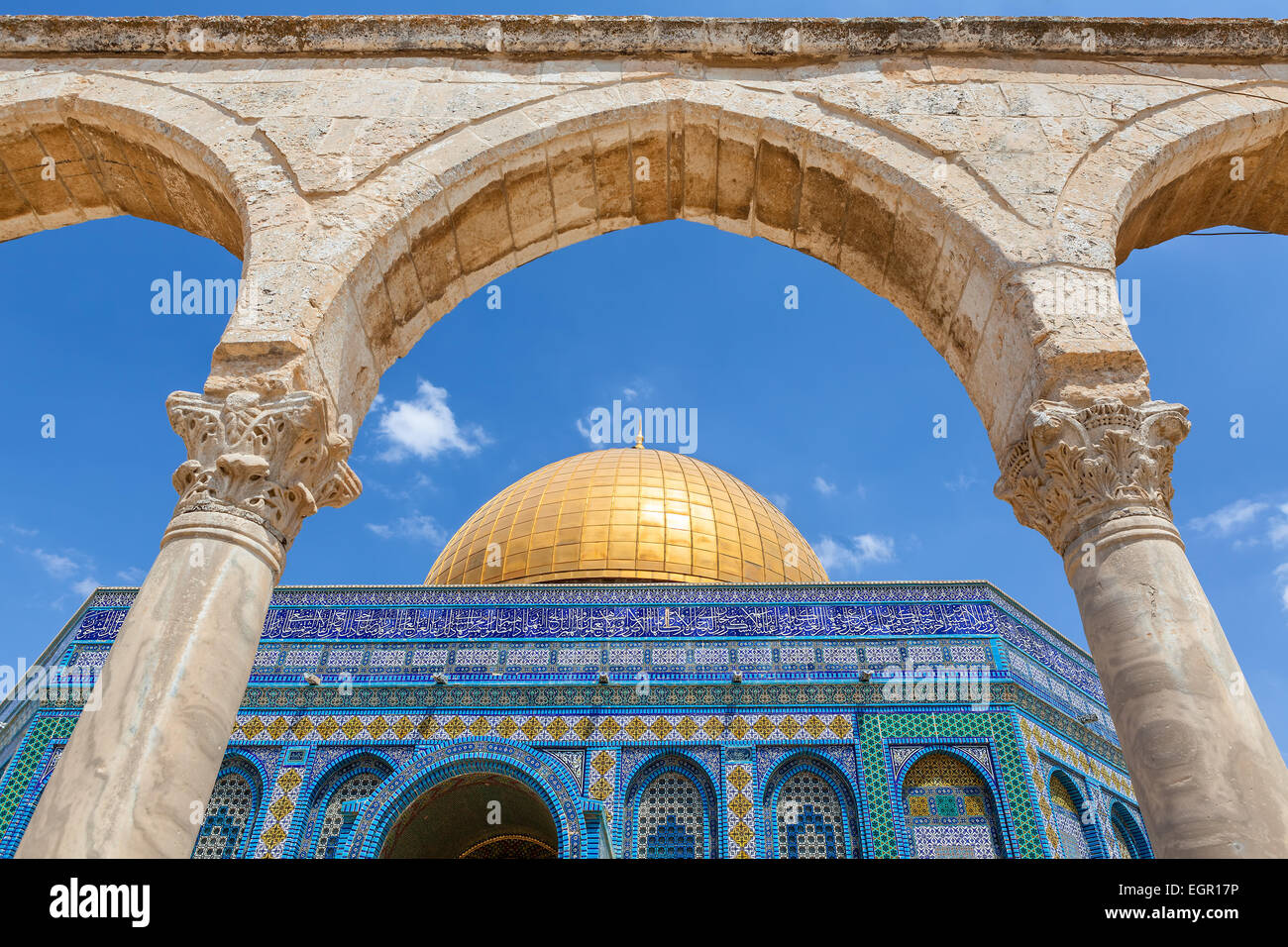 Ancient arch and Dome of the Rock Mosque under blue sky in Jerusalem ...