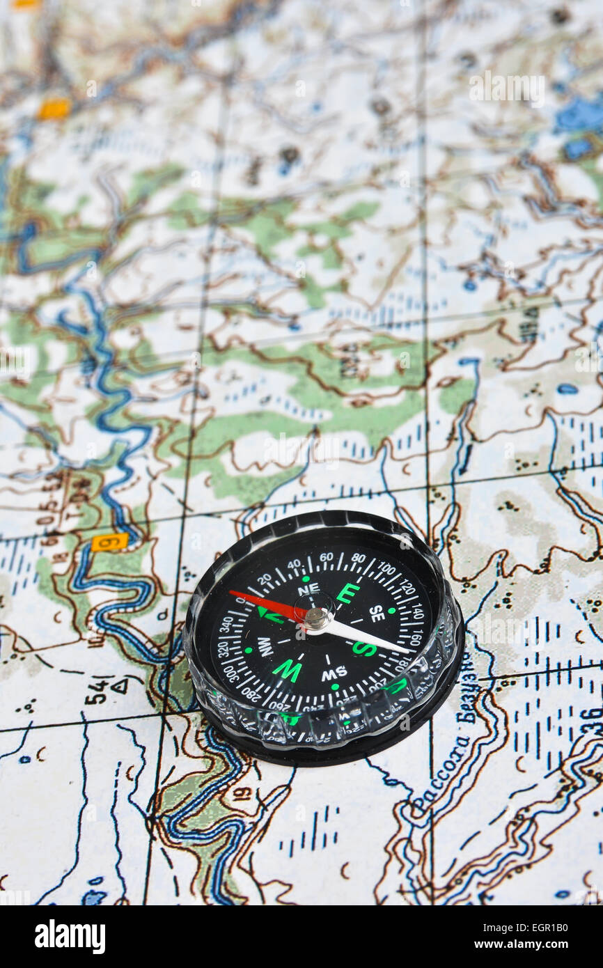 The magnetic compass and topographic map. Travel compass and map ...