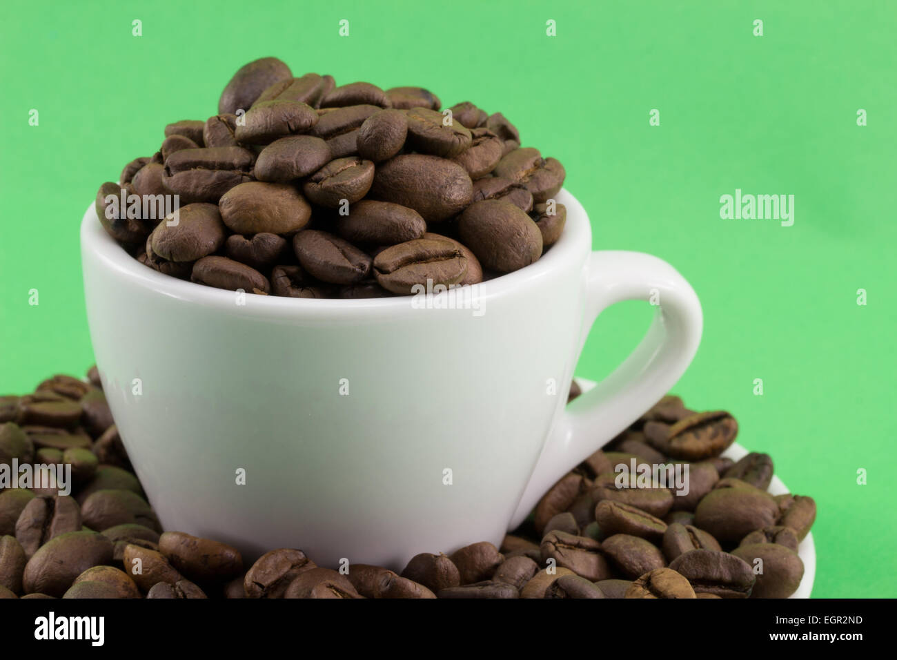 cup of coffee on green background Stock Photo - Alamy