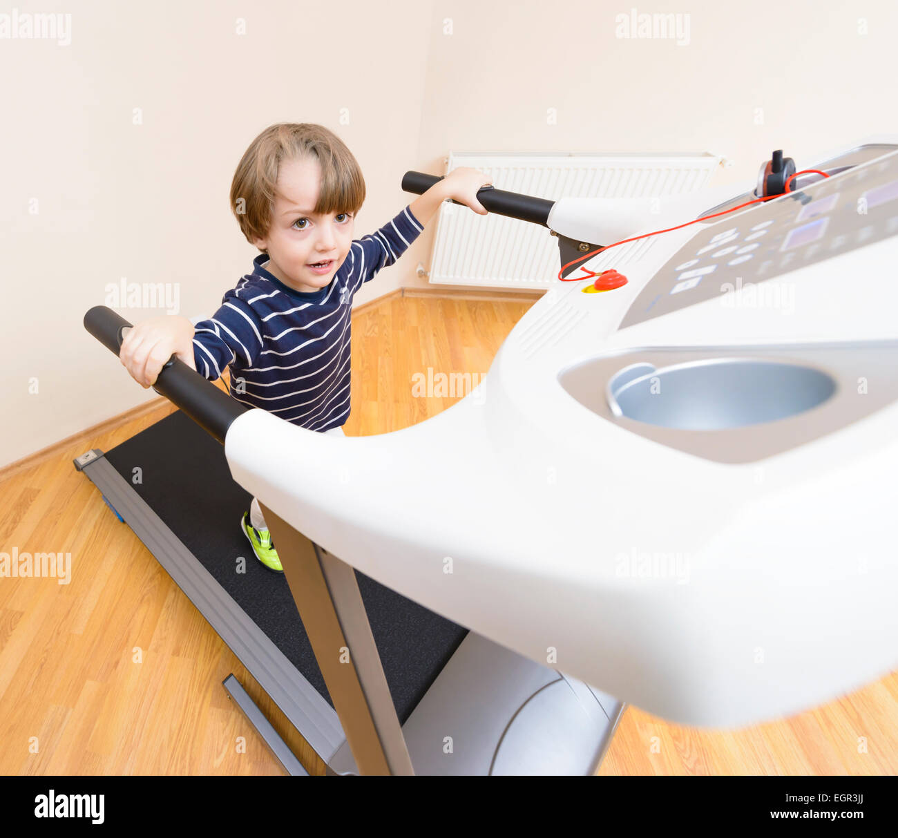 Cute boy running treadmill at home Stock Photo - Alamy