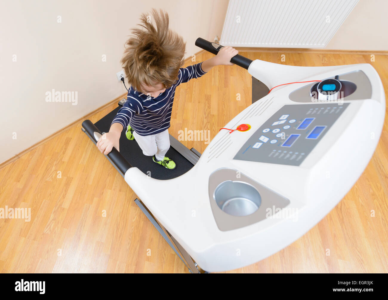 Cute boy running treadmill at home Stock Photo - Alamy