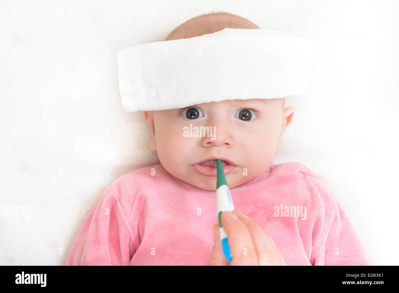 Checking temperature to a cute baby with a digital thermometer Stock ...