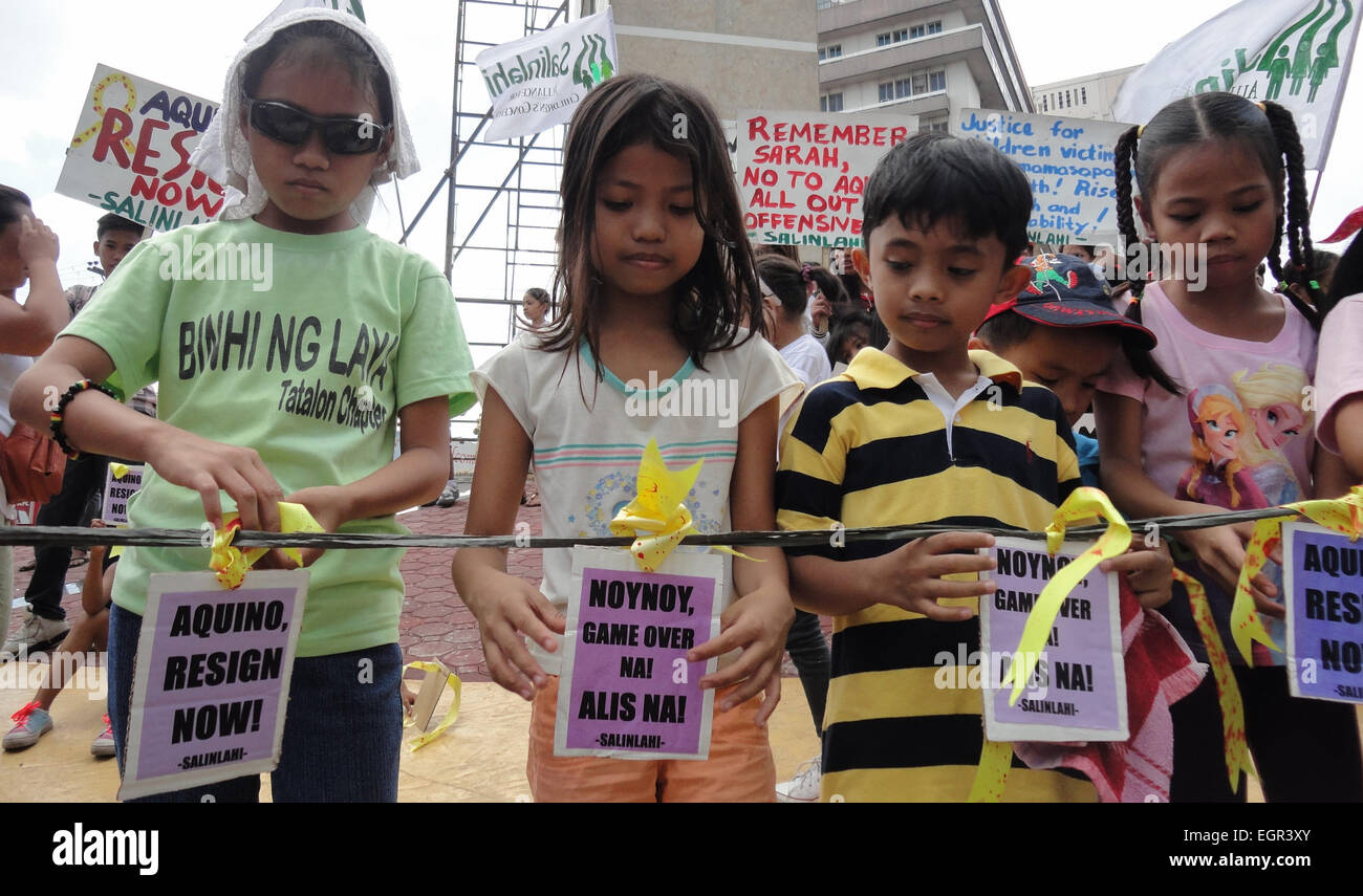 Filipino youth protesters tie placards with 'blood-stained' ribbons on ...