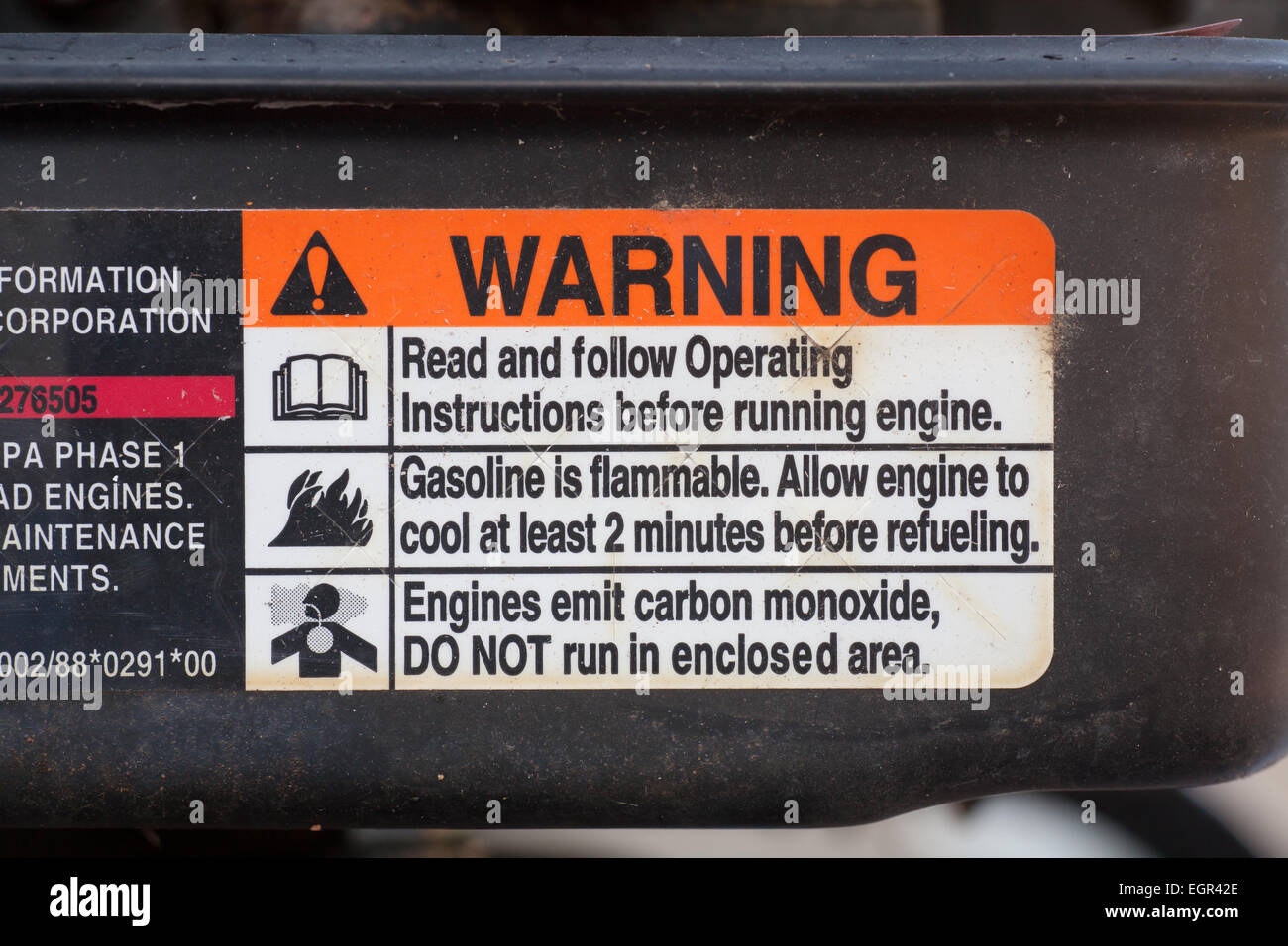 Warning signs or notices on a petrol engined lawnmower Stock Photo - Alamy