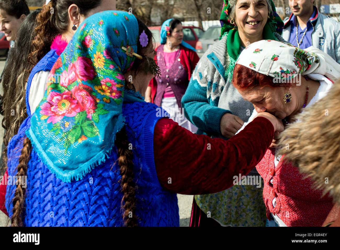A woman kisses her friends hand in the bride market. The annual ...