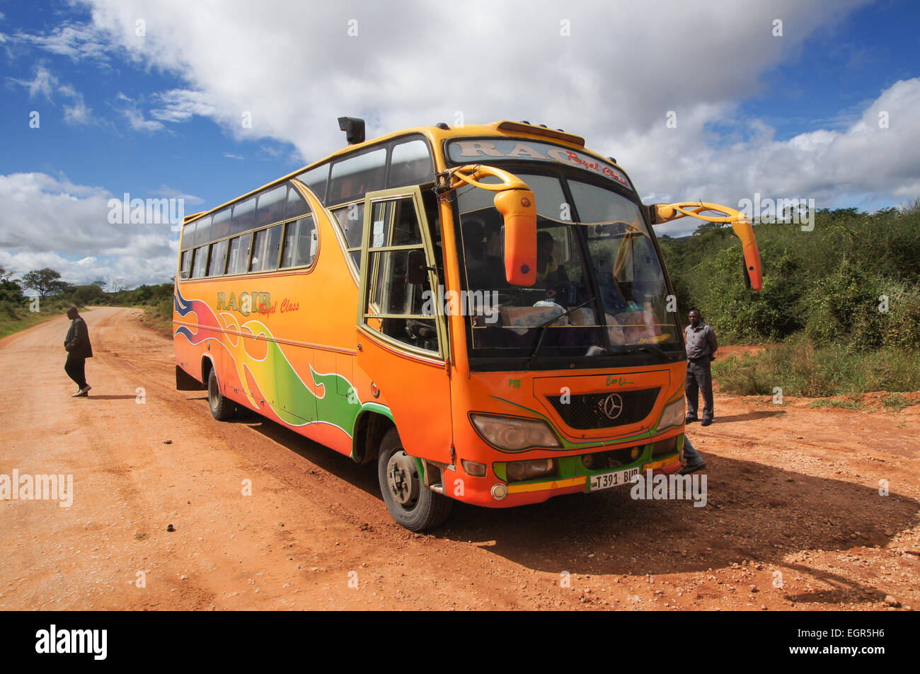 Orange bus on a dirt road broken down travelling from Nairobi, Kenya to ...