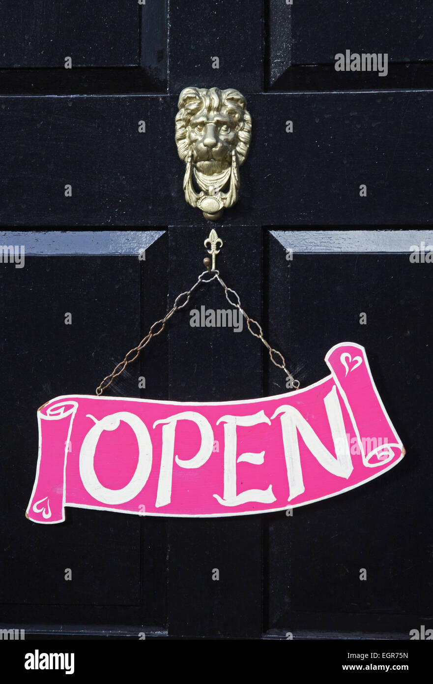 Pink Open sign hung on black door Stock Photo - Alamy