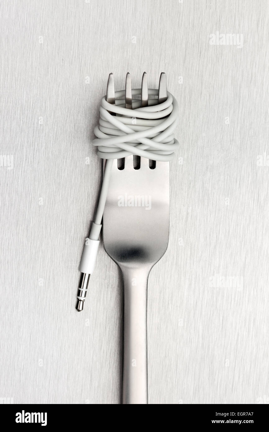 A shining fork with noodle made of cable with music jack plug in metal ...