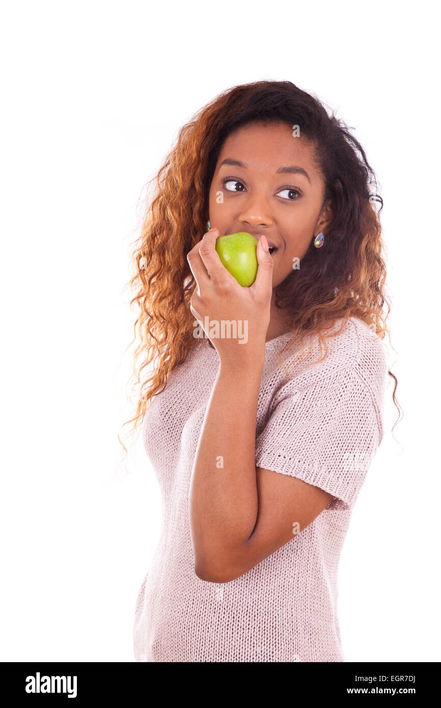 African American young woman eating one green apple Stock Photo - Alamy