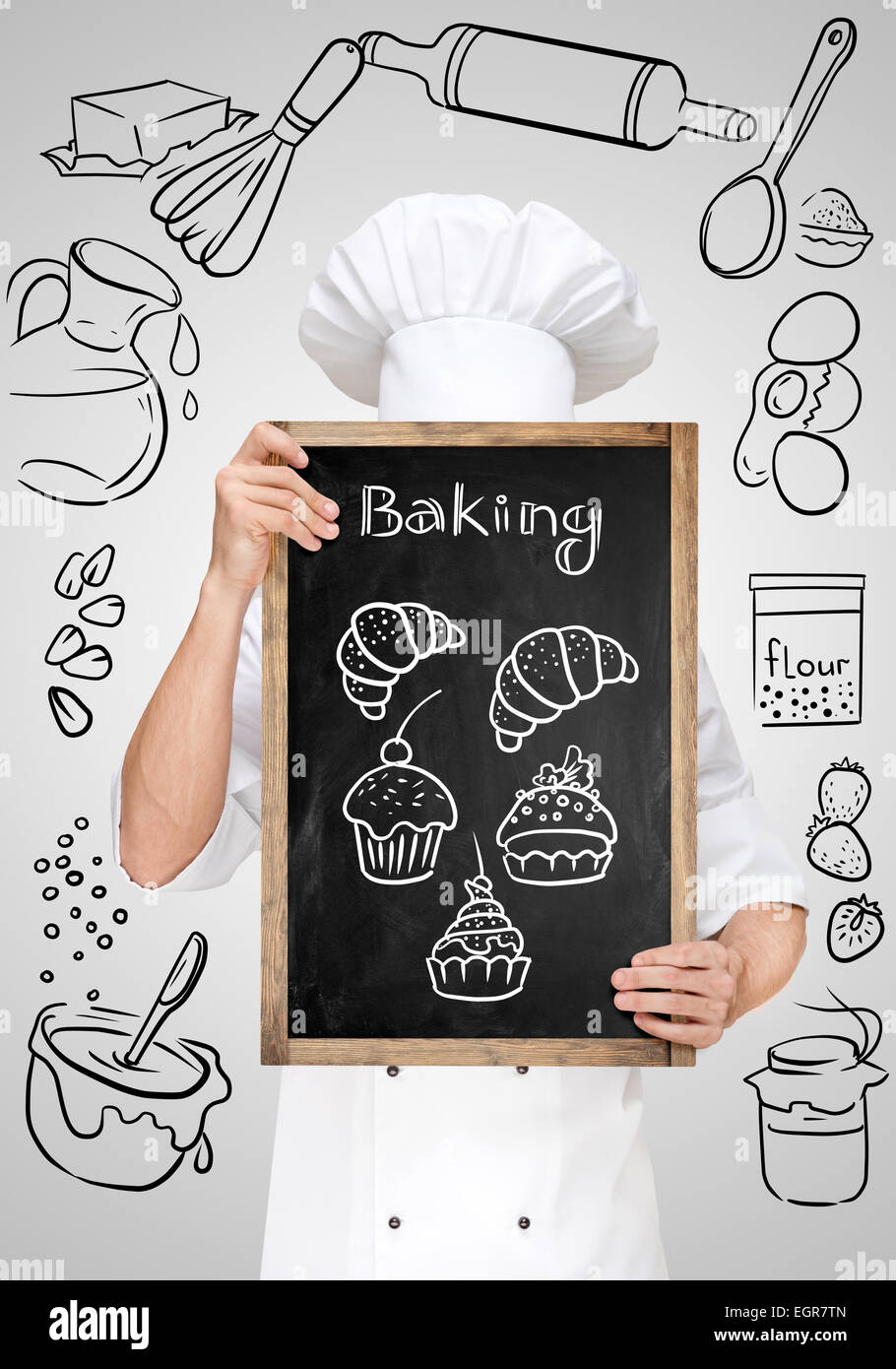 Restaurant chef hiding behind a chalkboard with sketchy bakery sweets ...