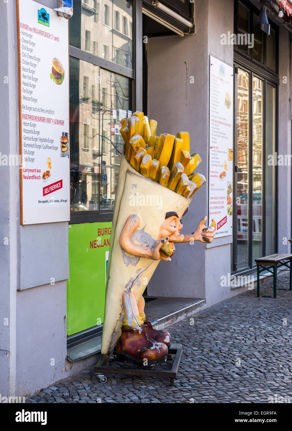Giant mascot, plaster of paris cone of chips eating hotdog outside fast ...