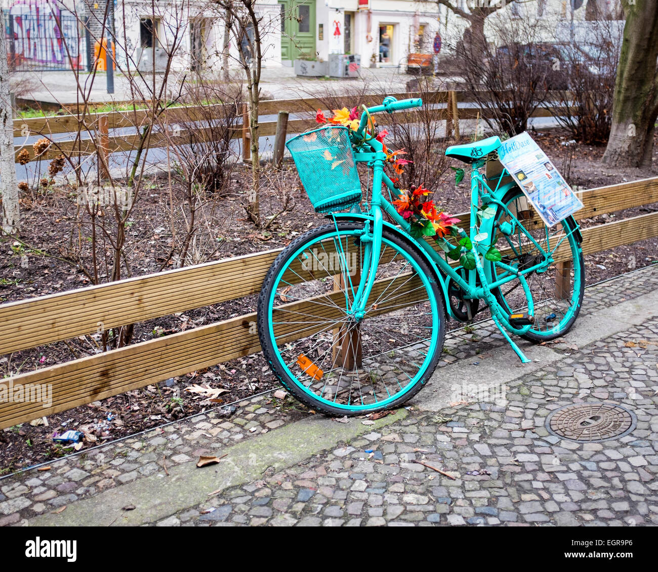 Bicycle street advertisement, Bright turquoise bike with ivy garland in ...