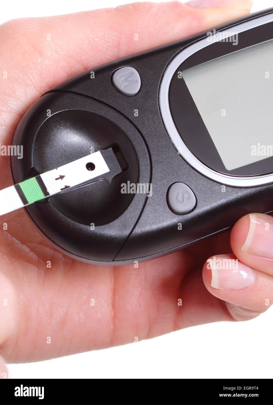 Closeup of strip for glucose testing and glucose meter, measuring sugar ...